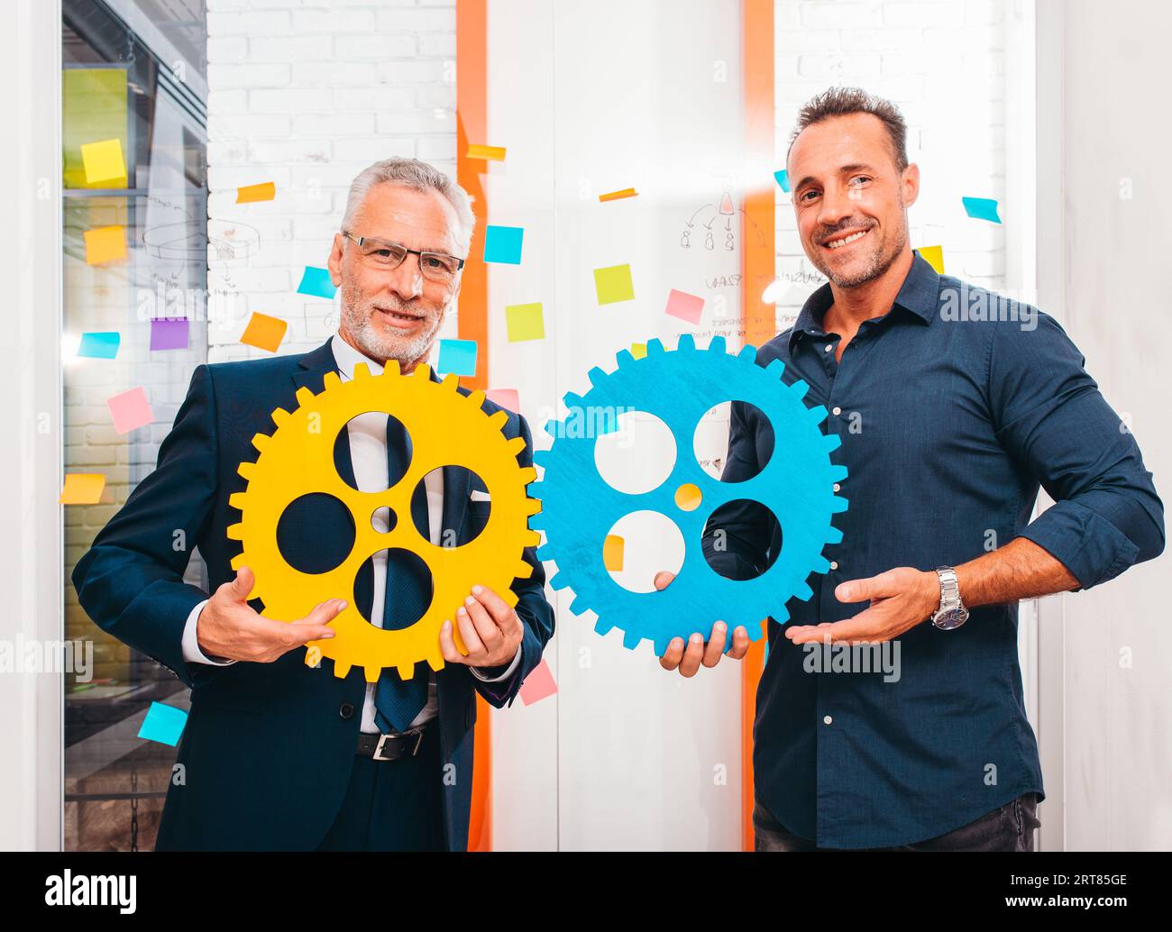 Business team work together and combine pieces of gears as partnership ...