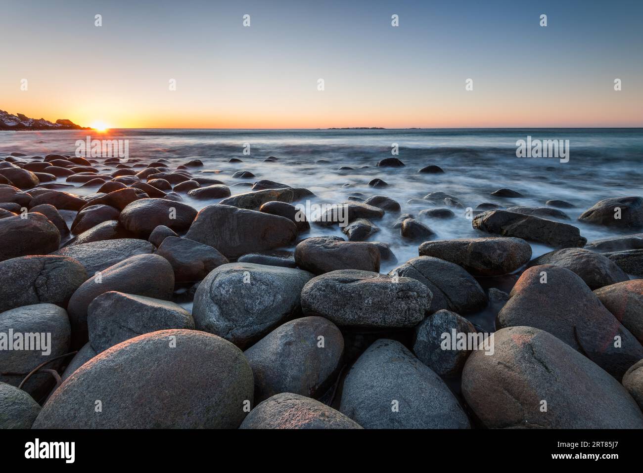 The famous beach near Uttakleiv with round shaped rock boulders on the ...