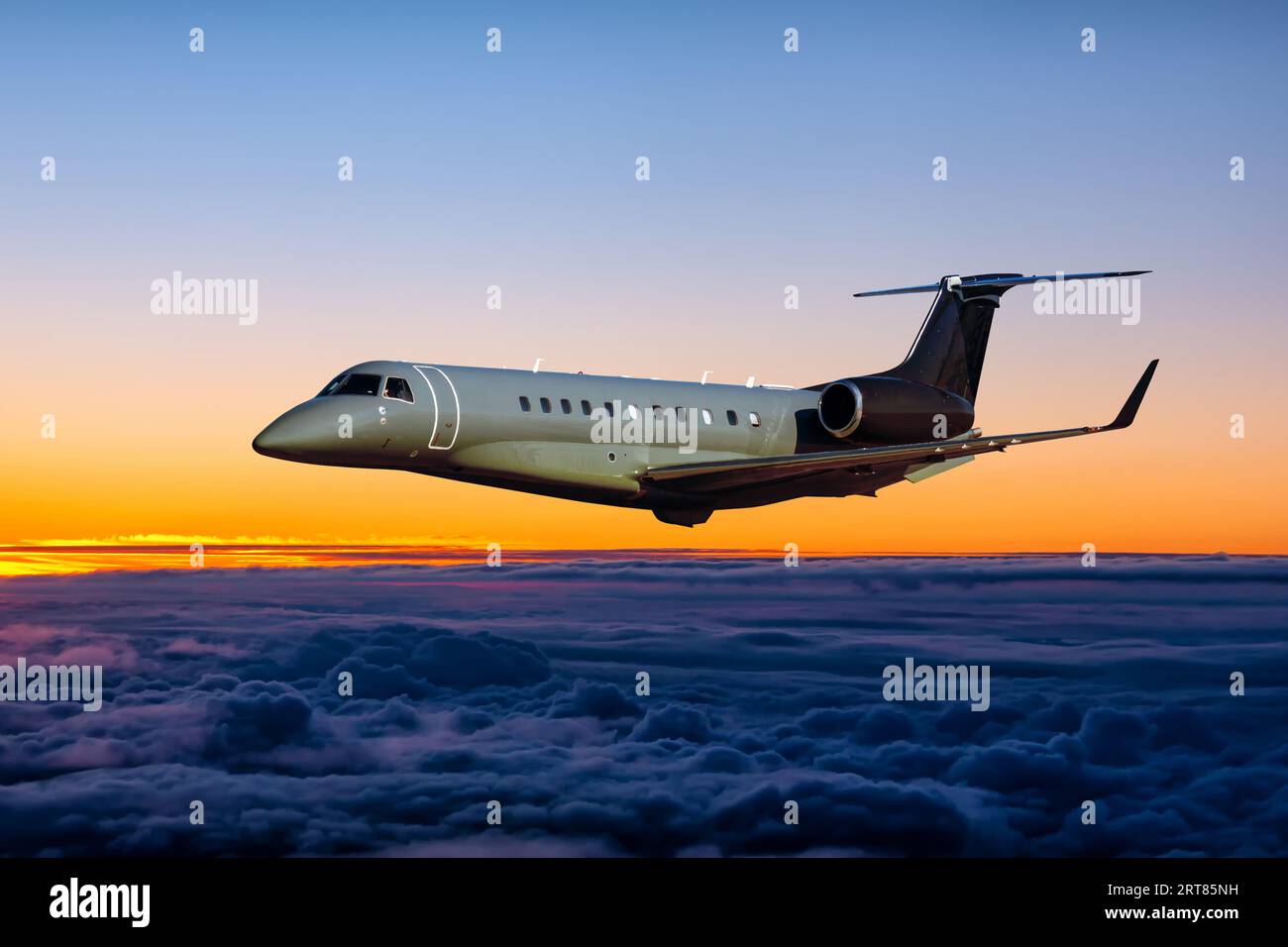 Modern luxury business jet fly in the sunrise sky Stock Photo - Alamy