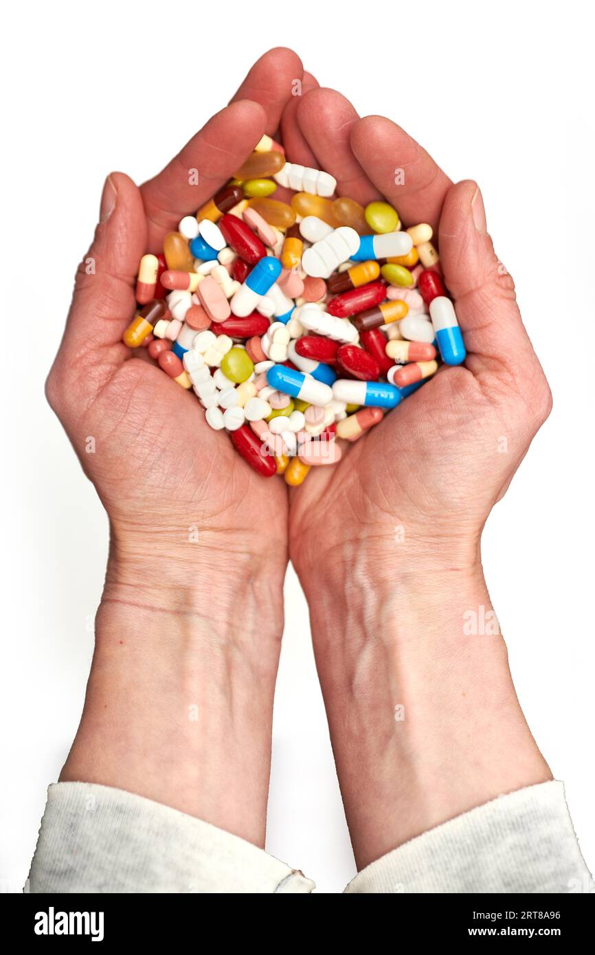 Two hands full of tablets and pills Stock Photo - Alamy