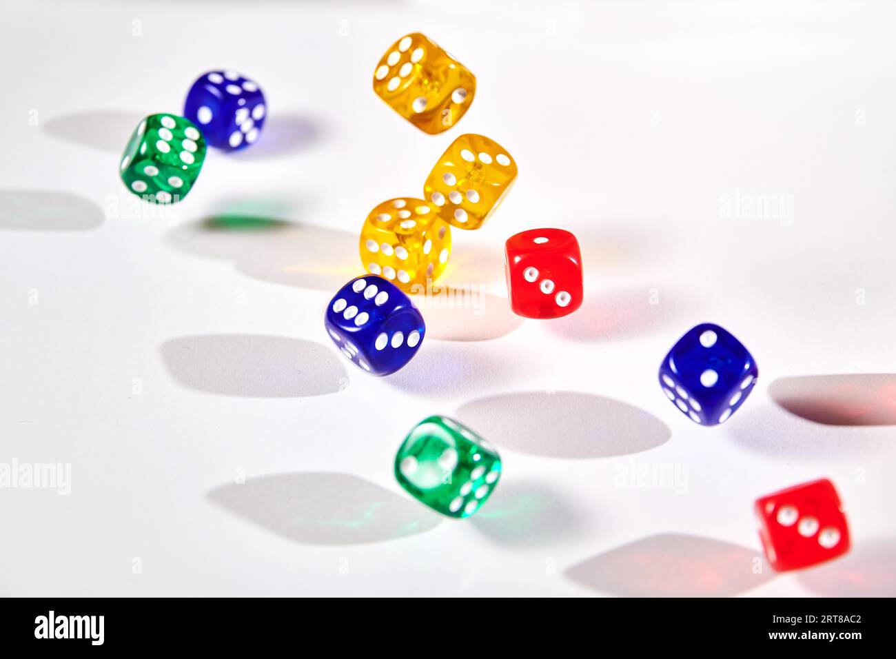 Colorful dices in motion on white background Stock Photo - Alamy