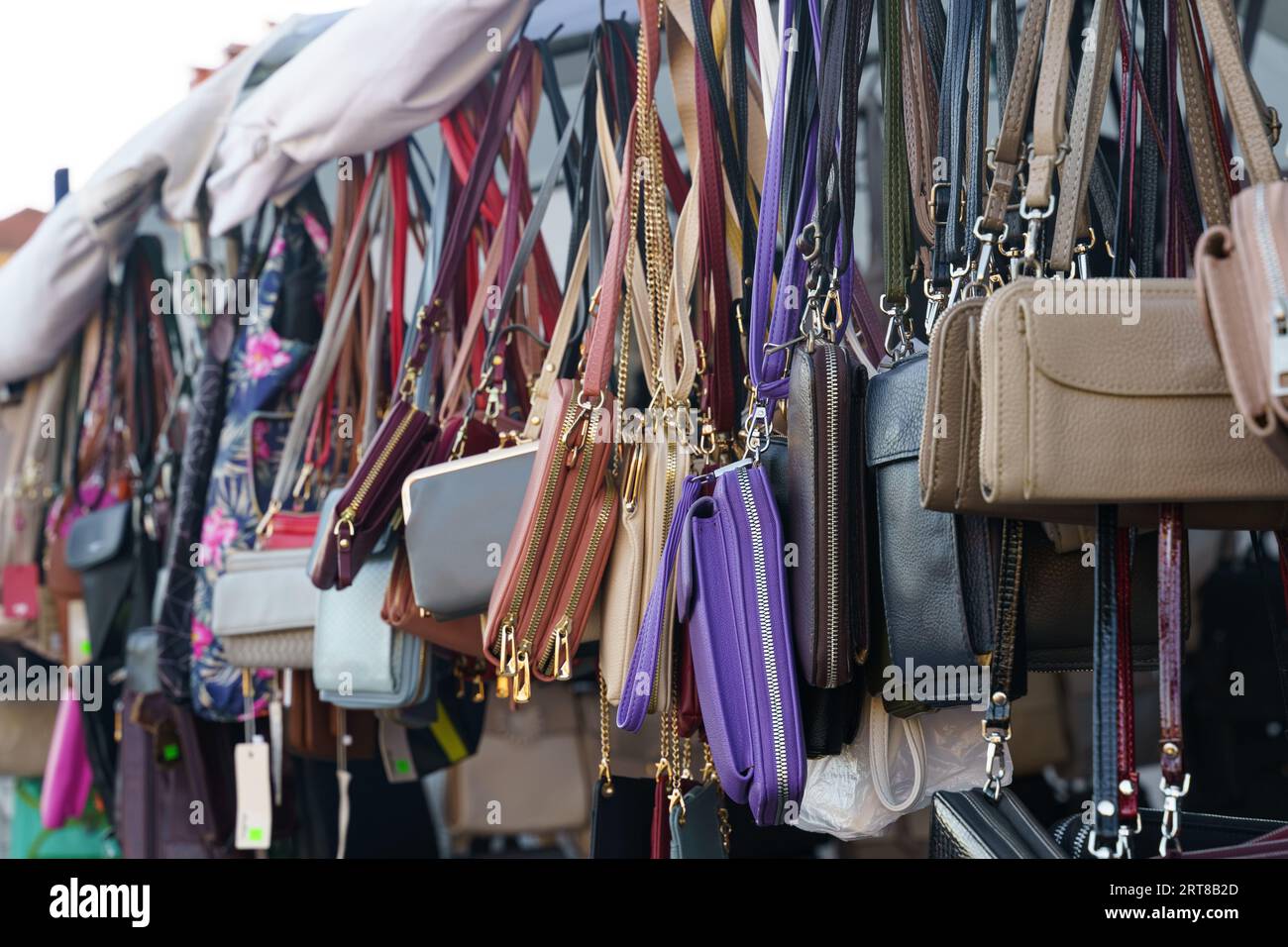 Showcase of a trade tent counter at a fair selling shoulder bags. Close ...