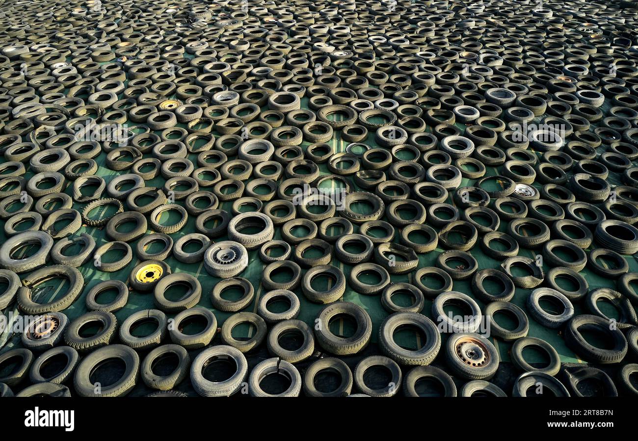 Tons of old used tyres in a mix Stock Photo - Alamy