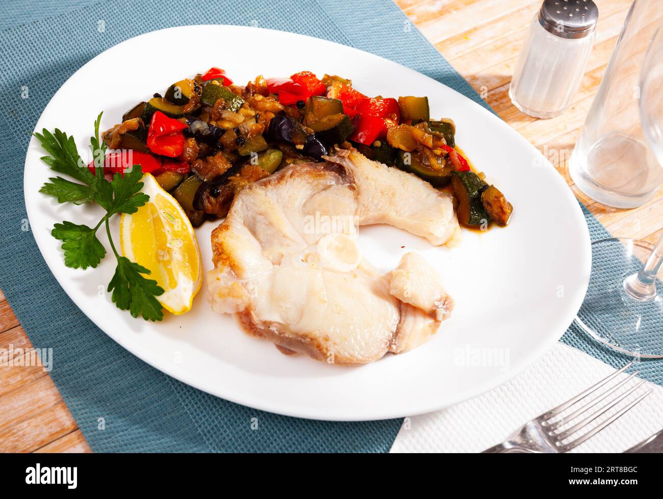 Roasted blue shark steak with vegetable saute, lemon and greens Stock ...