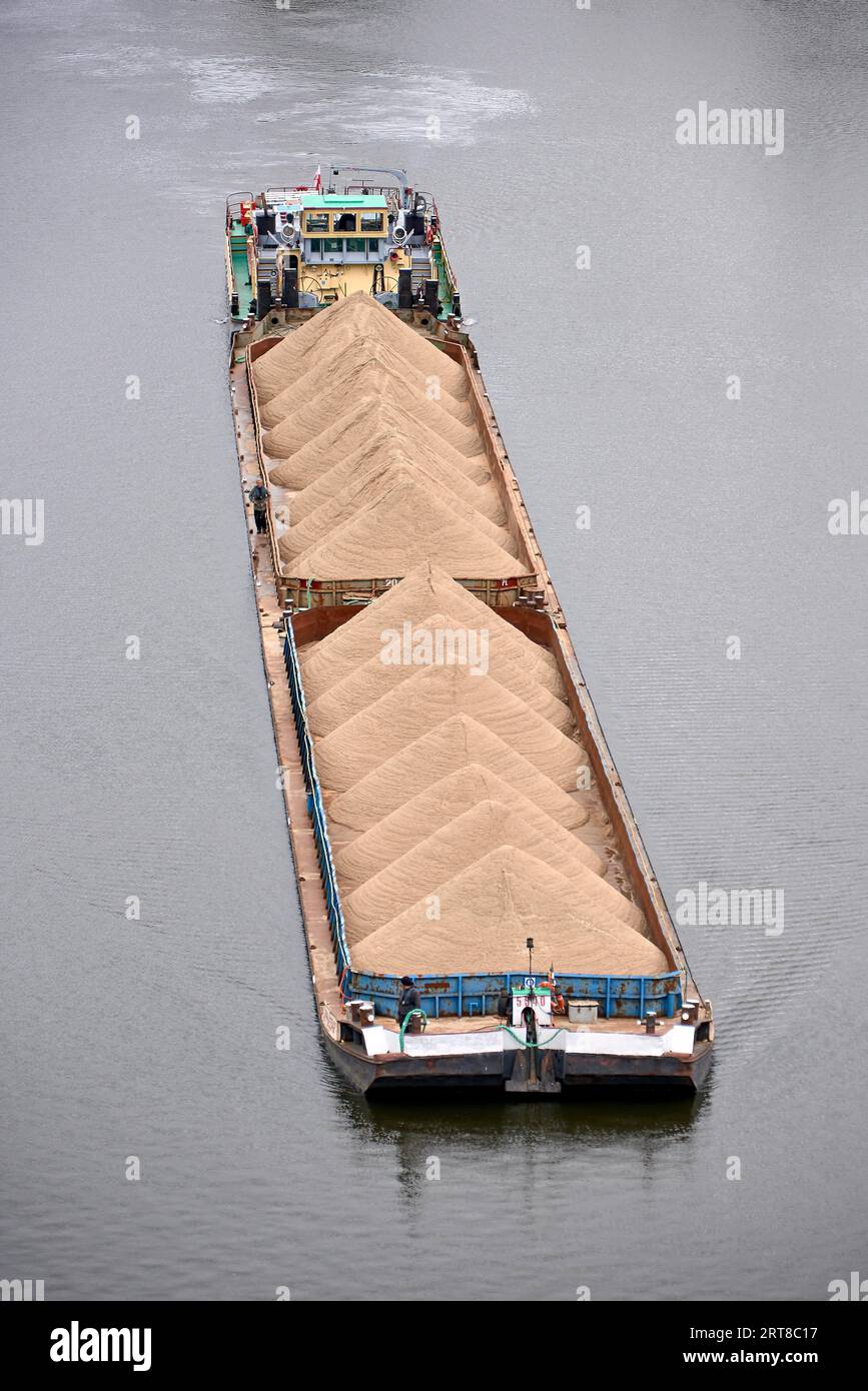 Vessel transporting gravel sand on a river Stock Photo - Alamy