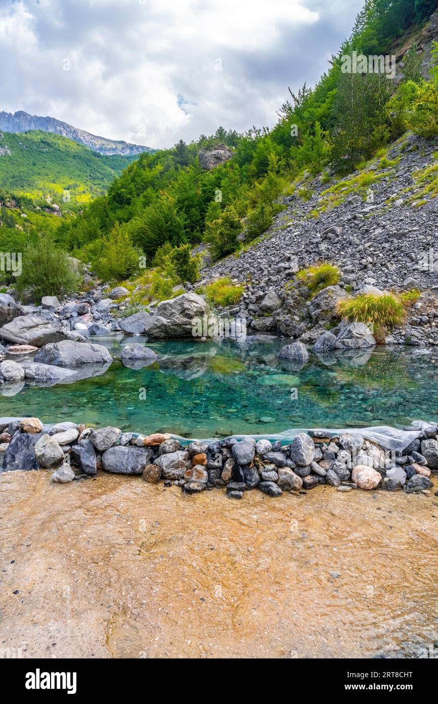 Turquoise water reservoir in the valley of Theth national park, Albania ...