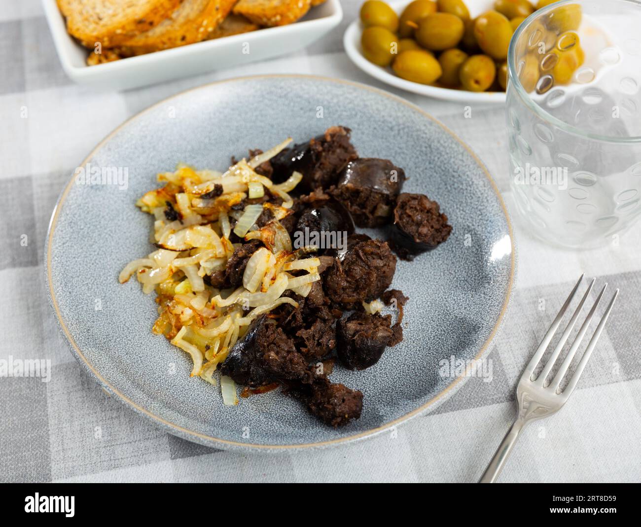 Spanish blood sausage morcilla served with grilled onion Stock Photo ...