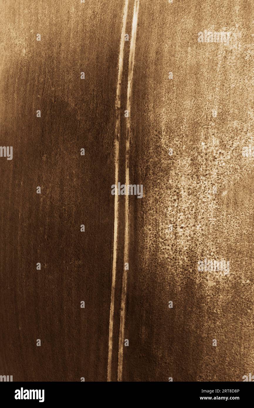 Drone shot, sepia colours, meadow path leads through agricultural ...