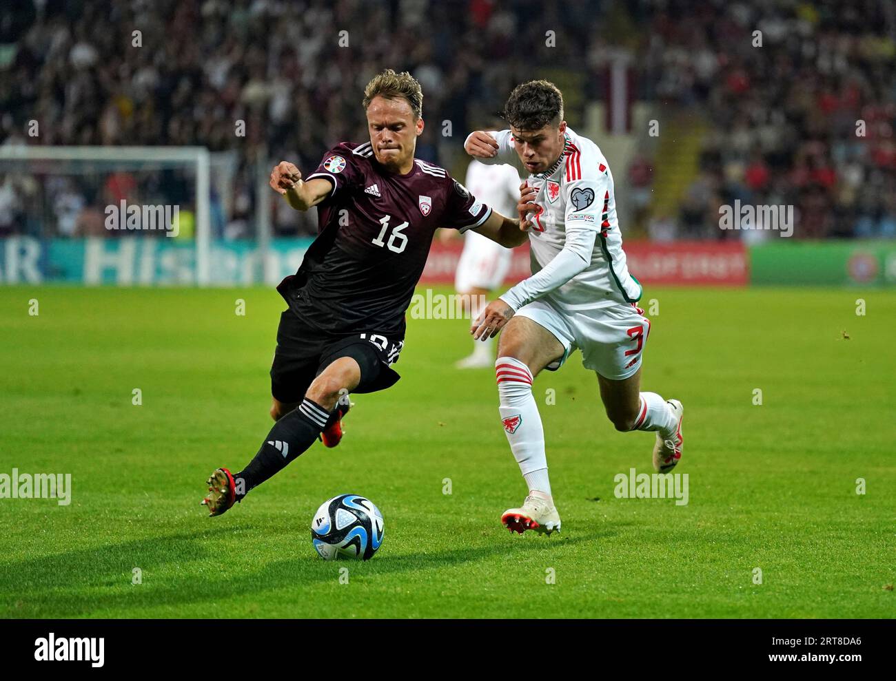 Latvia's Alvis Jaunzems and Wales' Neco Williams (right) battle for the ...