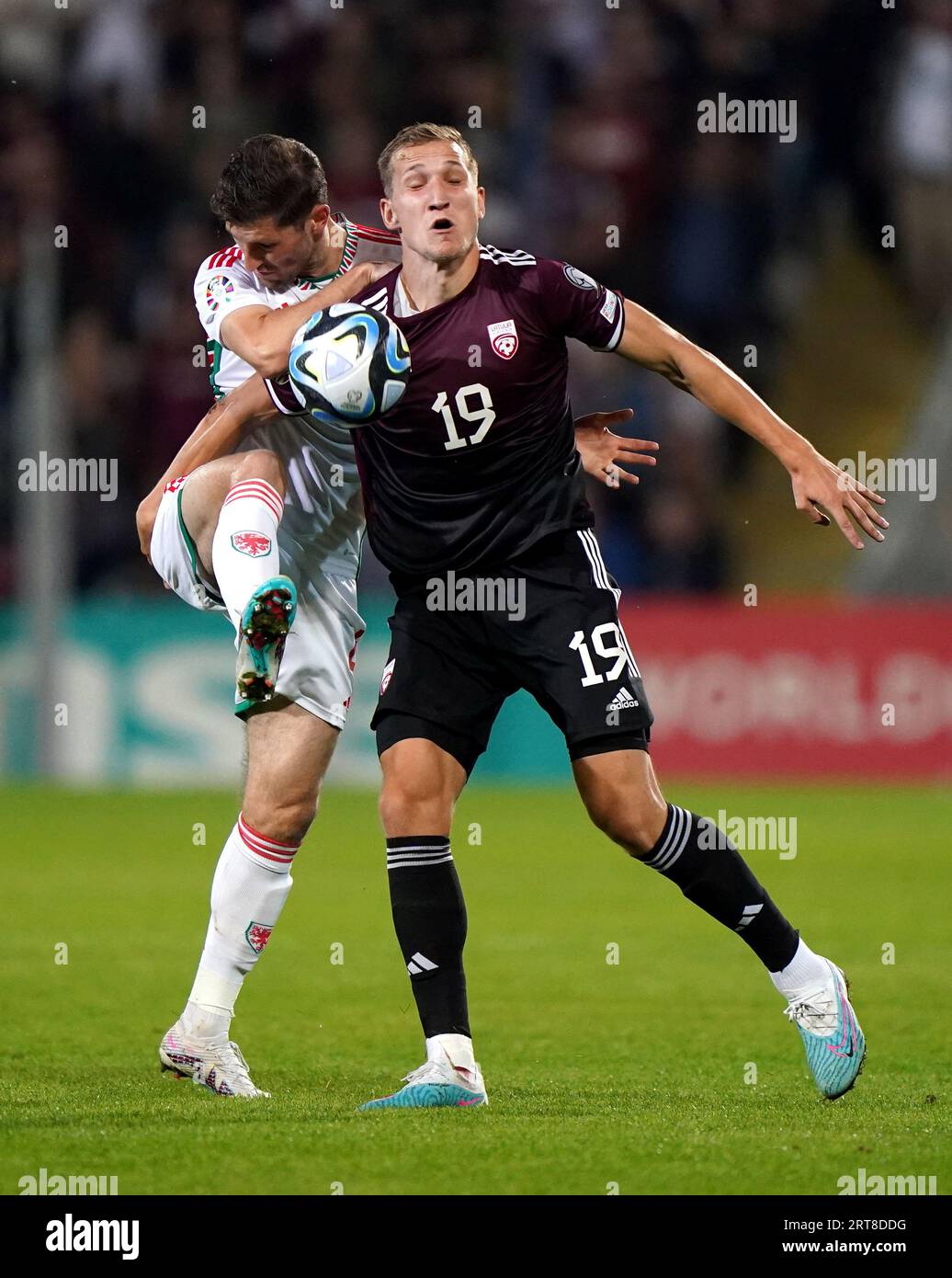 Wales' Ben Davies and Latvia's Raimonds Krollis (right) battle for the ...