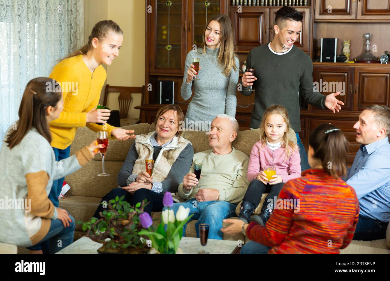 Happy family having conversation together Stock Photo - Alamy
