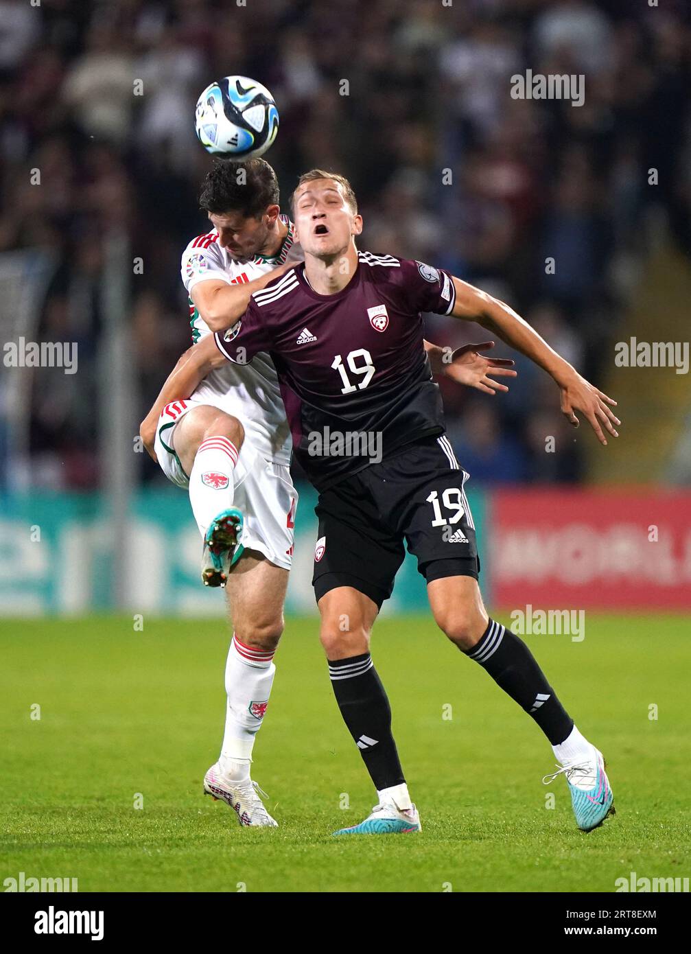 Wales' Ben Davies and Latvia's Raimonds Krollis (right) battle for the ...