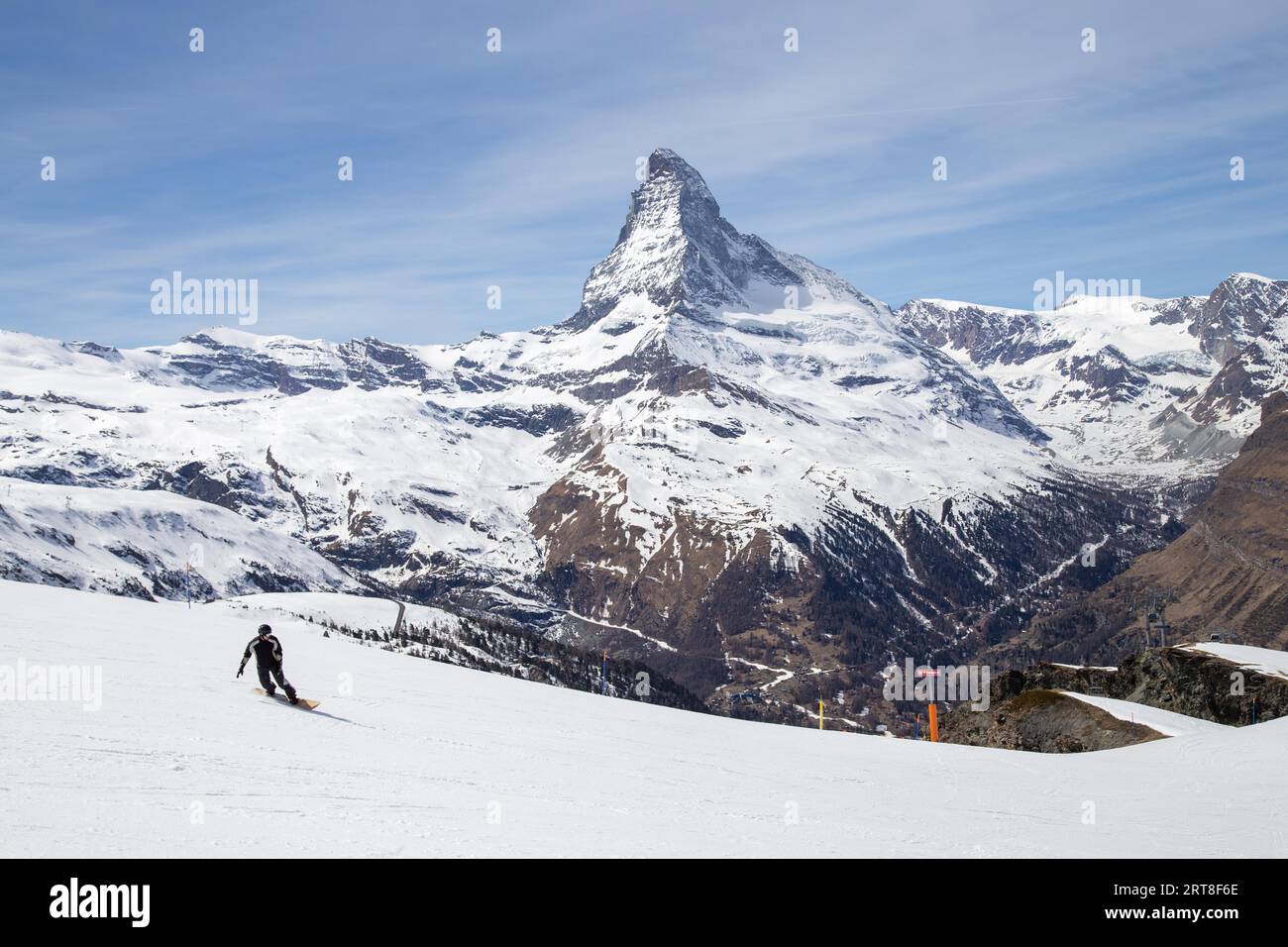 Zermatt, Switzerland, April 12, 2017: A man snowboarding on a skiing ...