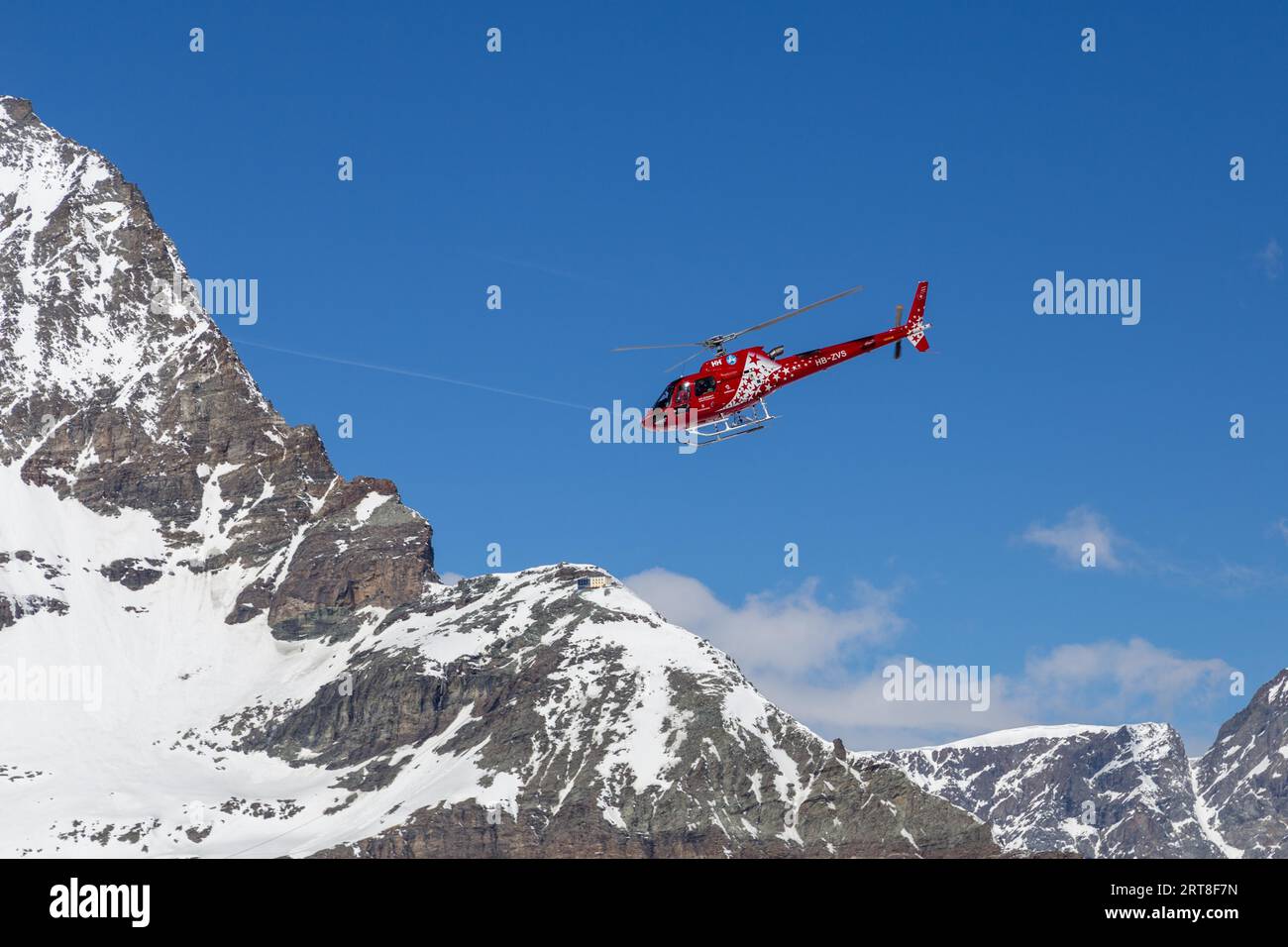 Zermatt, Switzerland, April 13, 2017: A red rescue helicopter flying in ...