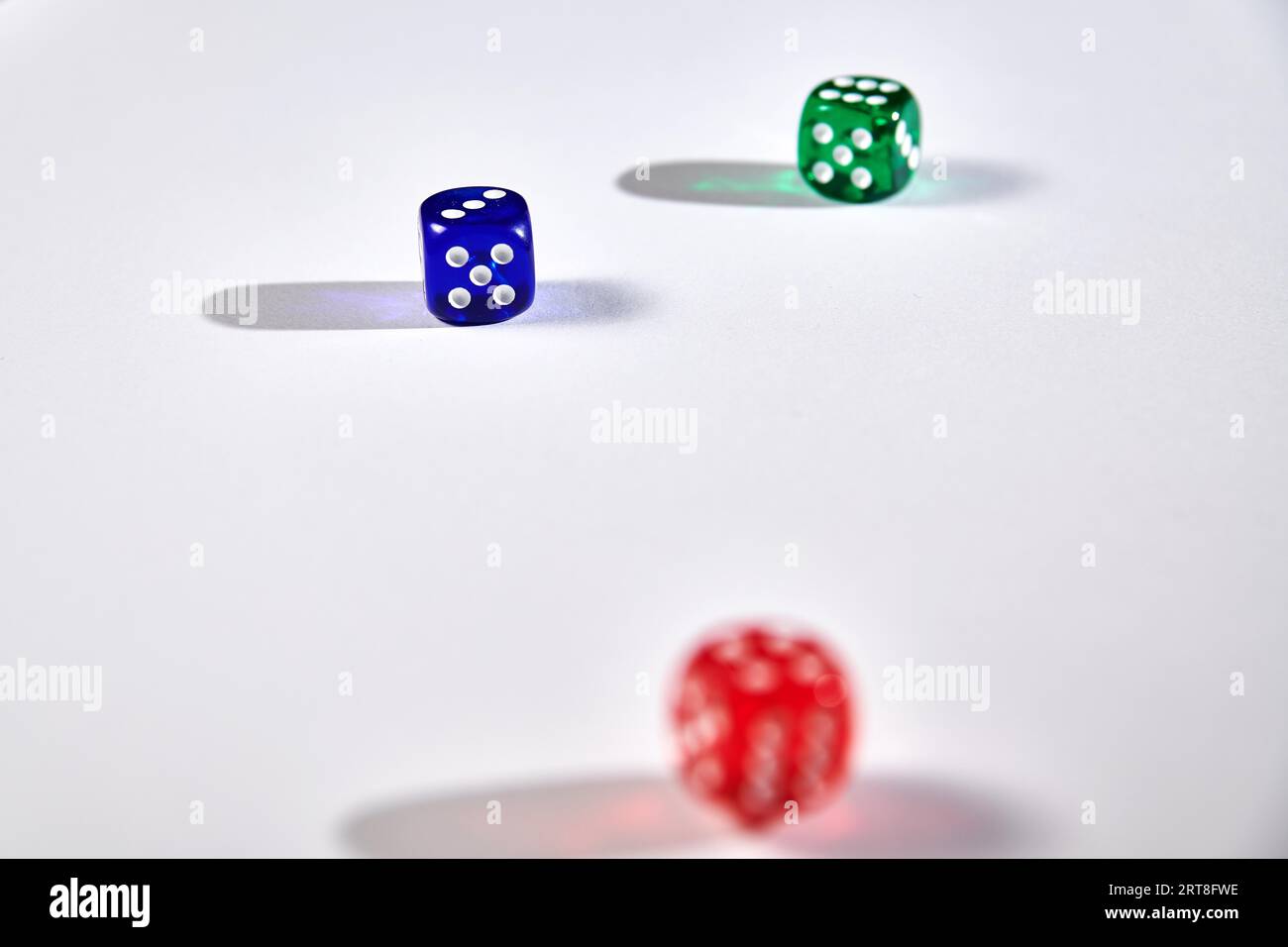 Colorful dices in motion on white background Stock Photo - Alamy