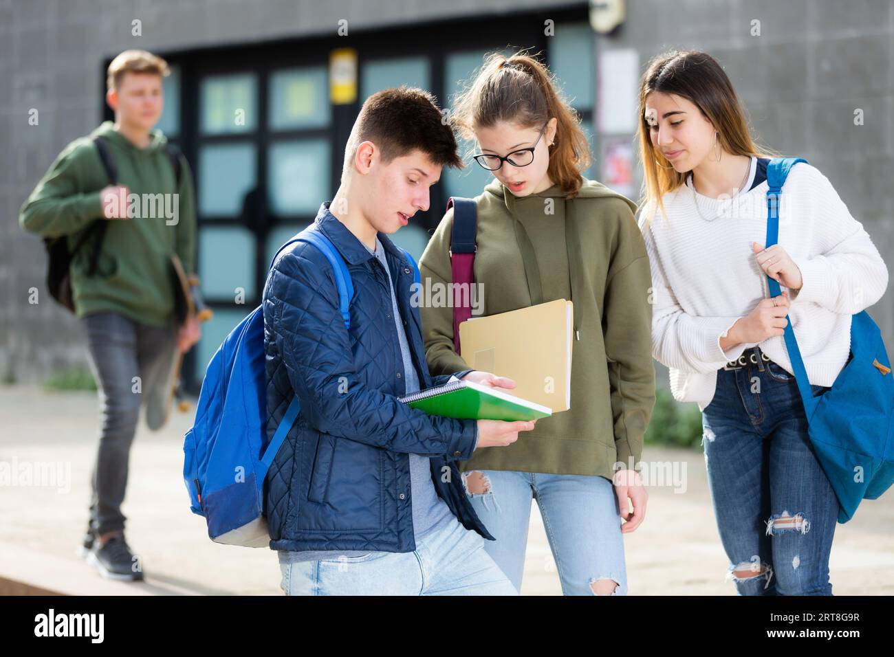 Teenage students talking outside between lessons Stock Photo - Alamy