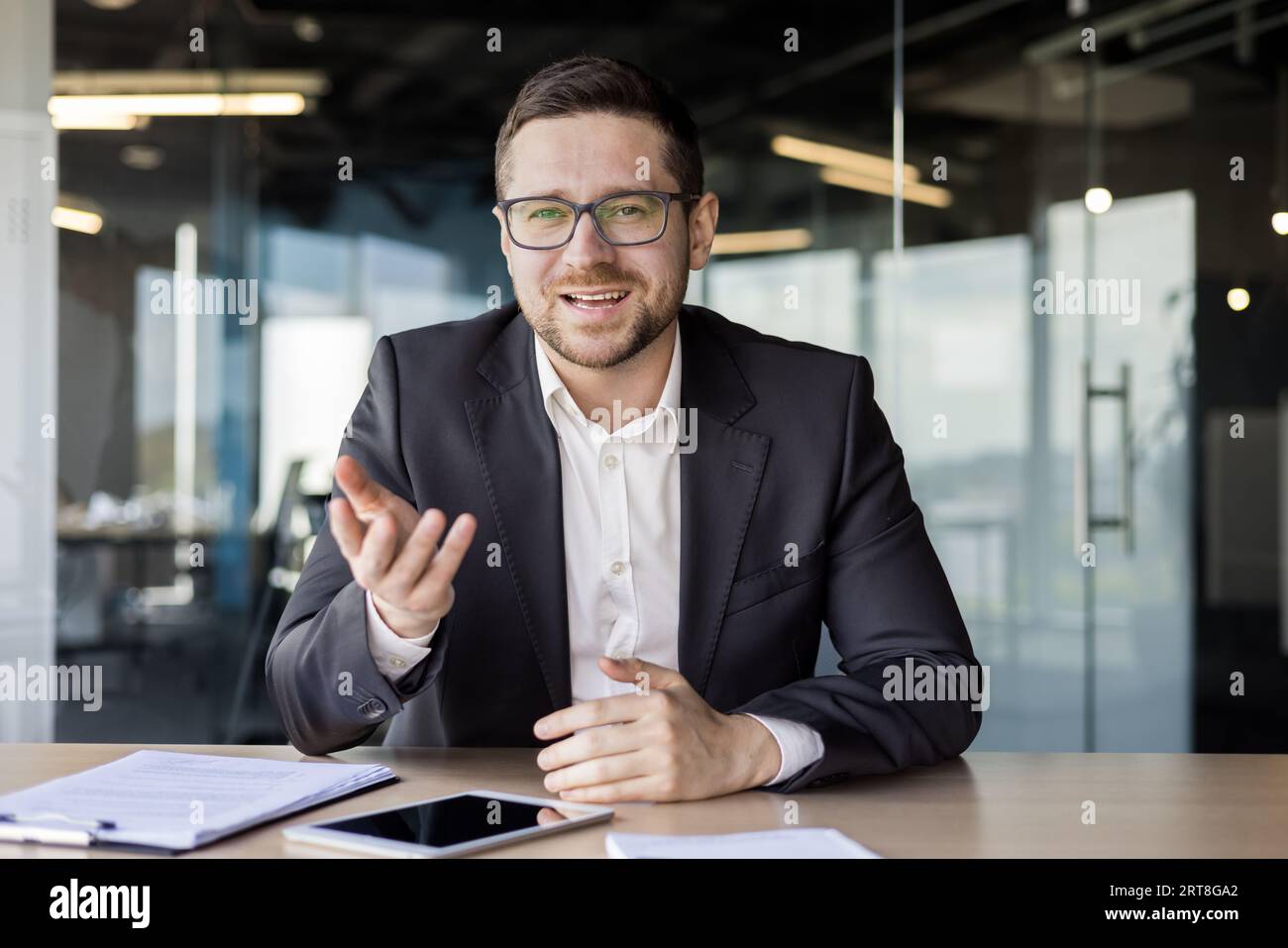Portrait of a young businessman, a business coach conducts training and ...