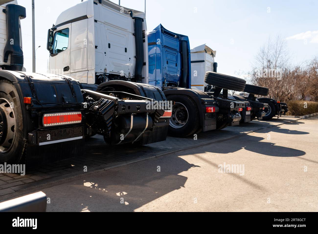 Semi truck fleet at the logistics center Stock Photo - Alamy