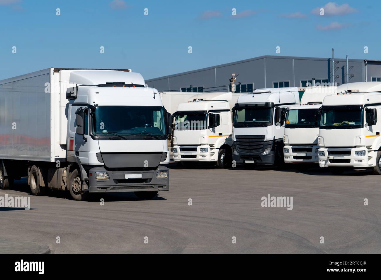 Semi truck fleet at the logistics center Stock Photo - Alamy
