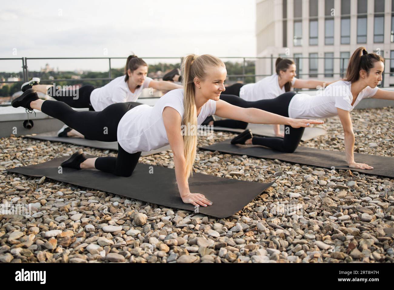 Group yoga class on terrace hi-res stock photography and images - Alamy