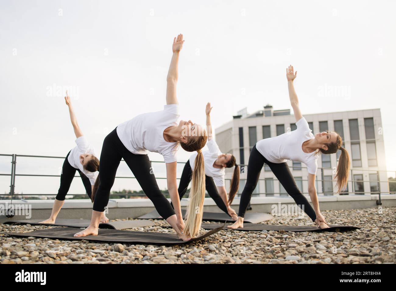 Group yoga class on terrace hi-res stock photography and images - Alamy