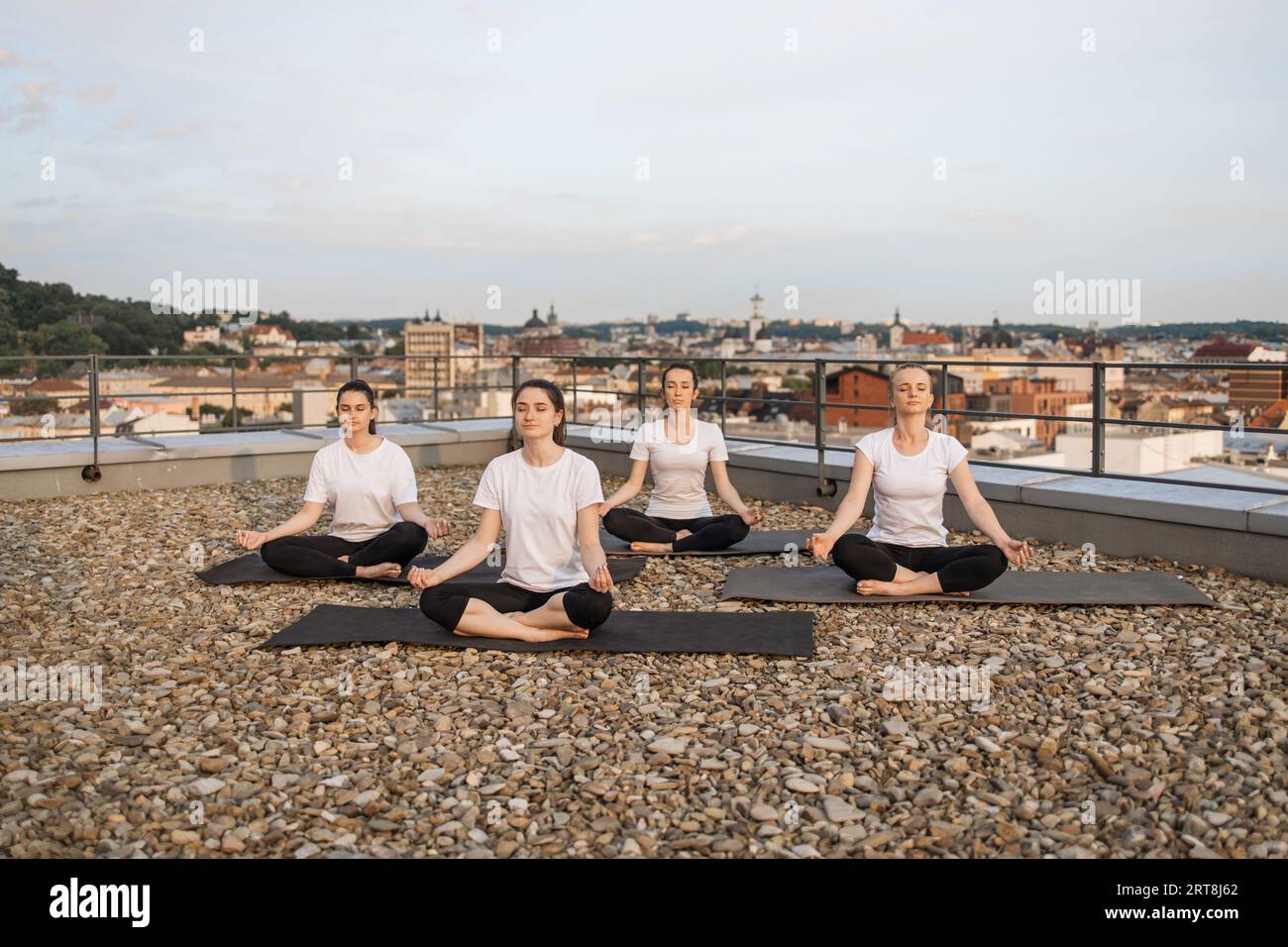 Group yoga class on terrace hi-res stock photography and images - Alamy
