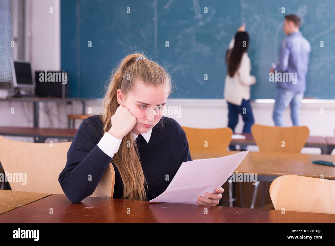 Young sad girl preparing for the exam in classroom Stock Photo - Alamy