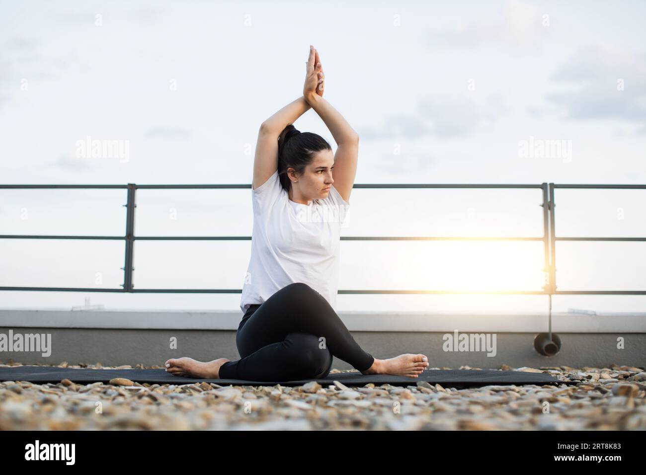 Fit lady getting into grounding pose in outside exercises Stock Photo ...