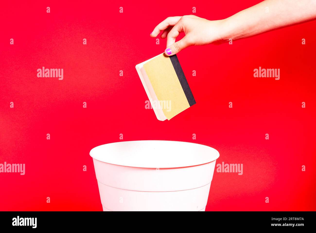 Throw notepad, notebook or diary into trash bin, notepad in hand in ...