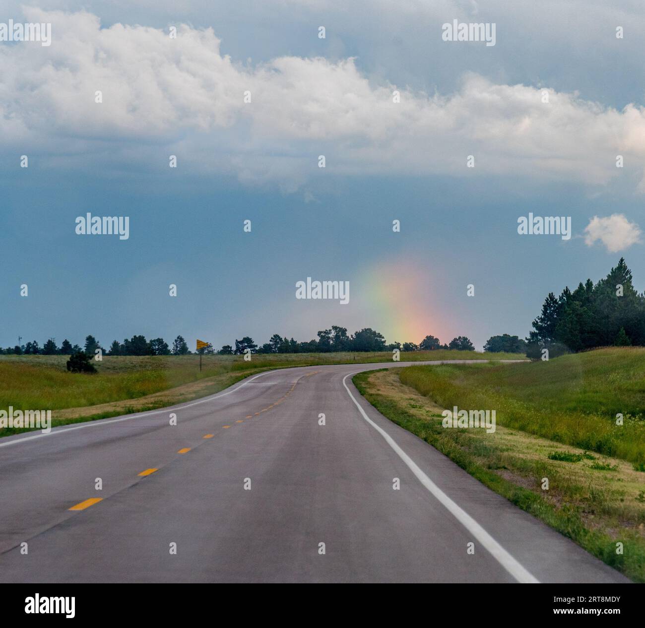 A rainbow appears on the road after the storm Stock Photo - Alamy