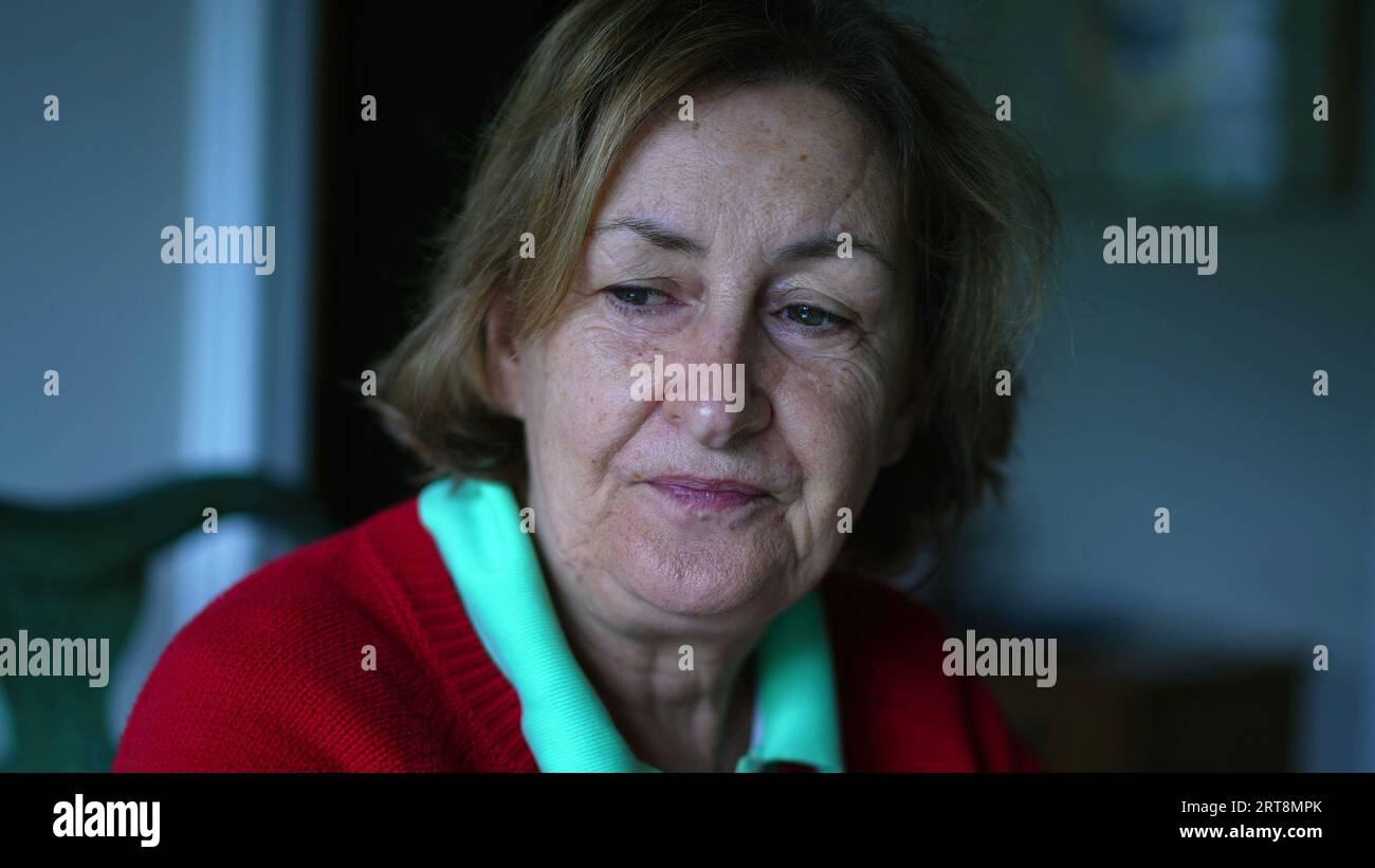 Senior woman in deep mental reflection, contemplative expression of ...