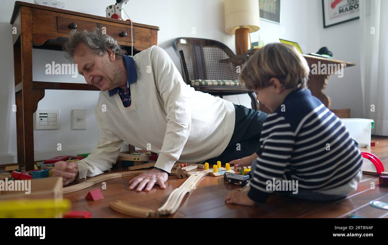 Inter-generational Bonding Over Wooden Train Track Assembly, Grandpa ...