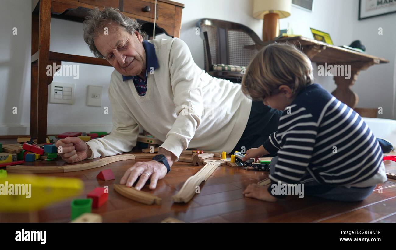 Inter-generational Bonding Over Wooden Train Track Assembly, Grandpa ...