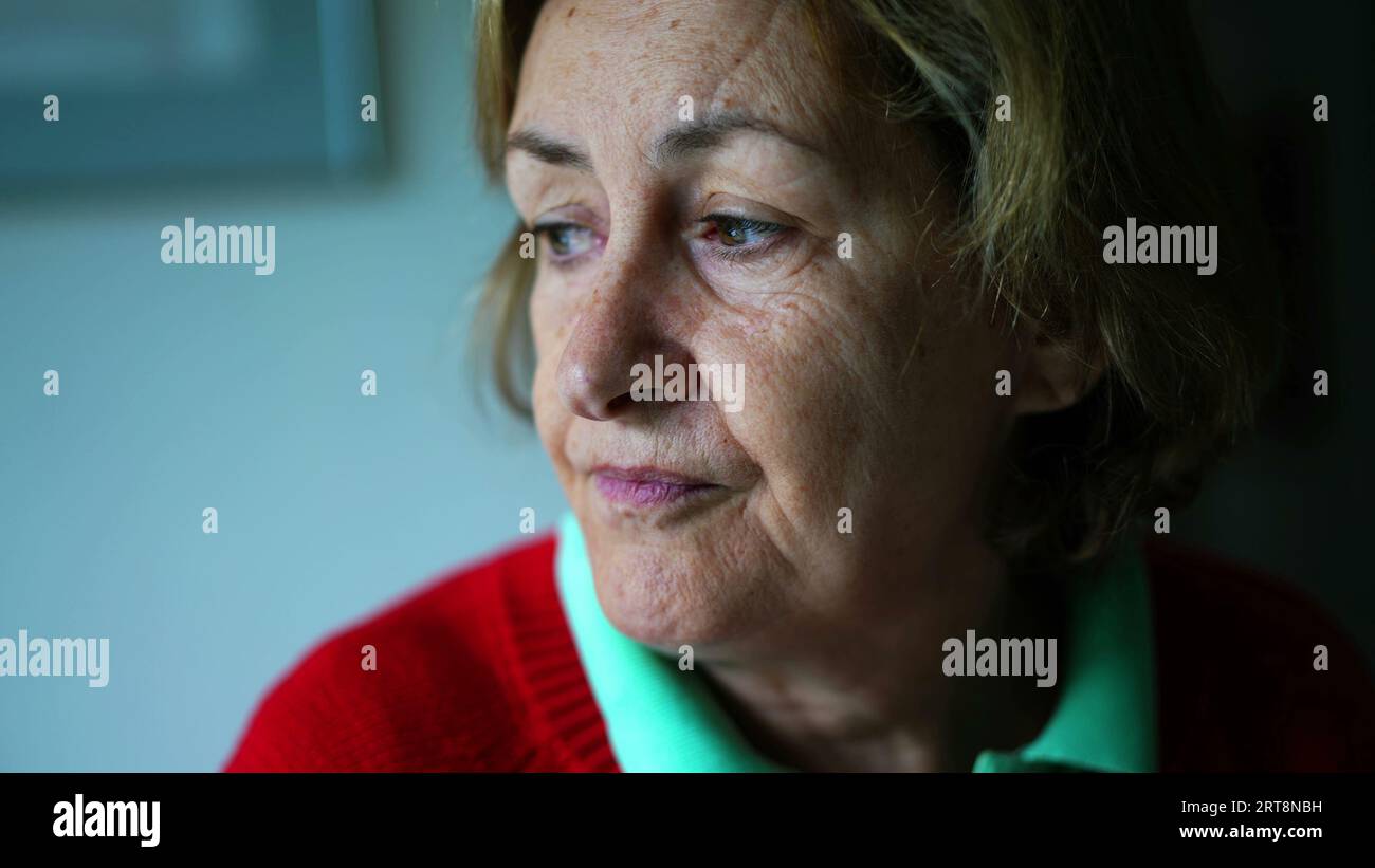 Pensive senior woman close-up face with thoughtful expression ...
