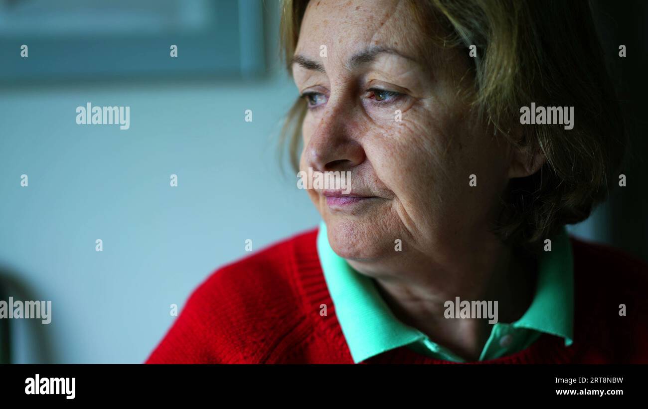 Pensive senior woman close-up face with thoughtful expression ...