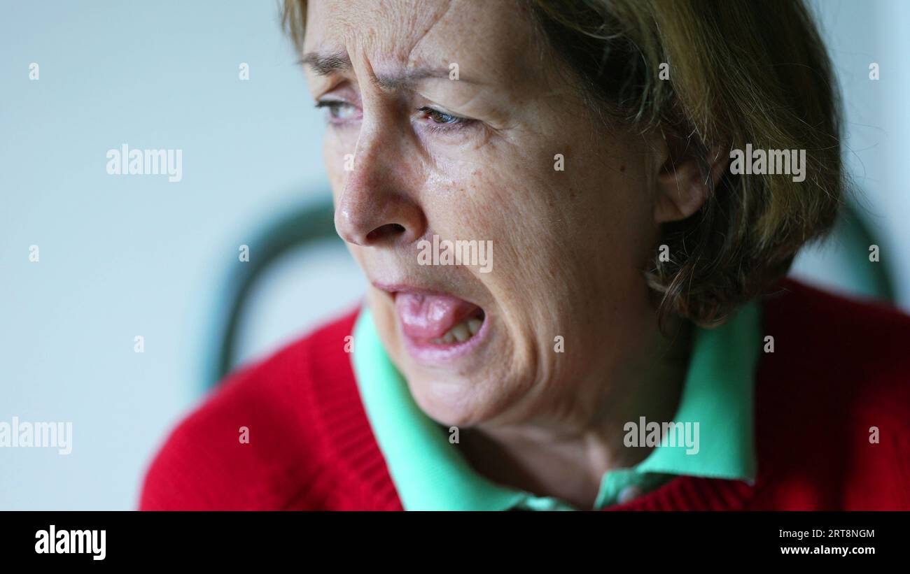 Sad Senior woman close-up face with exaggerated emotional expression of ...