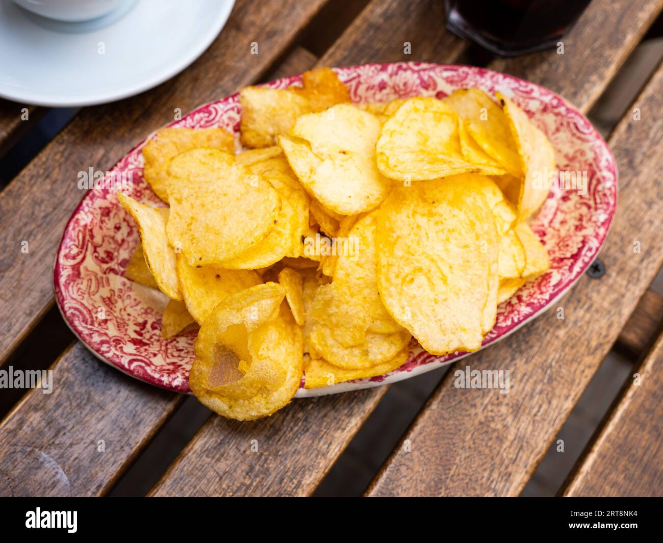 Round potato chips served in plate with a glass of vermouth Stock Photo ...