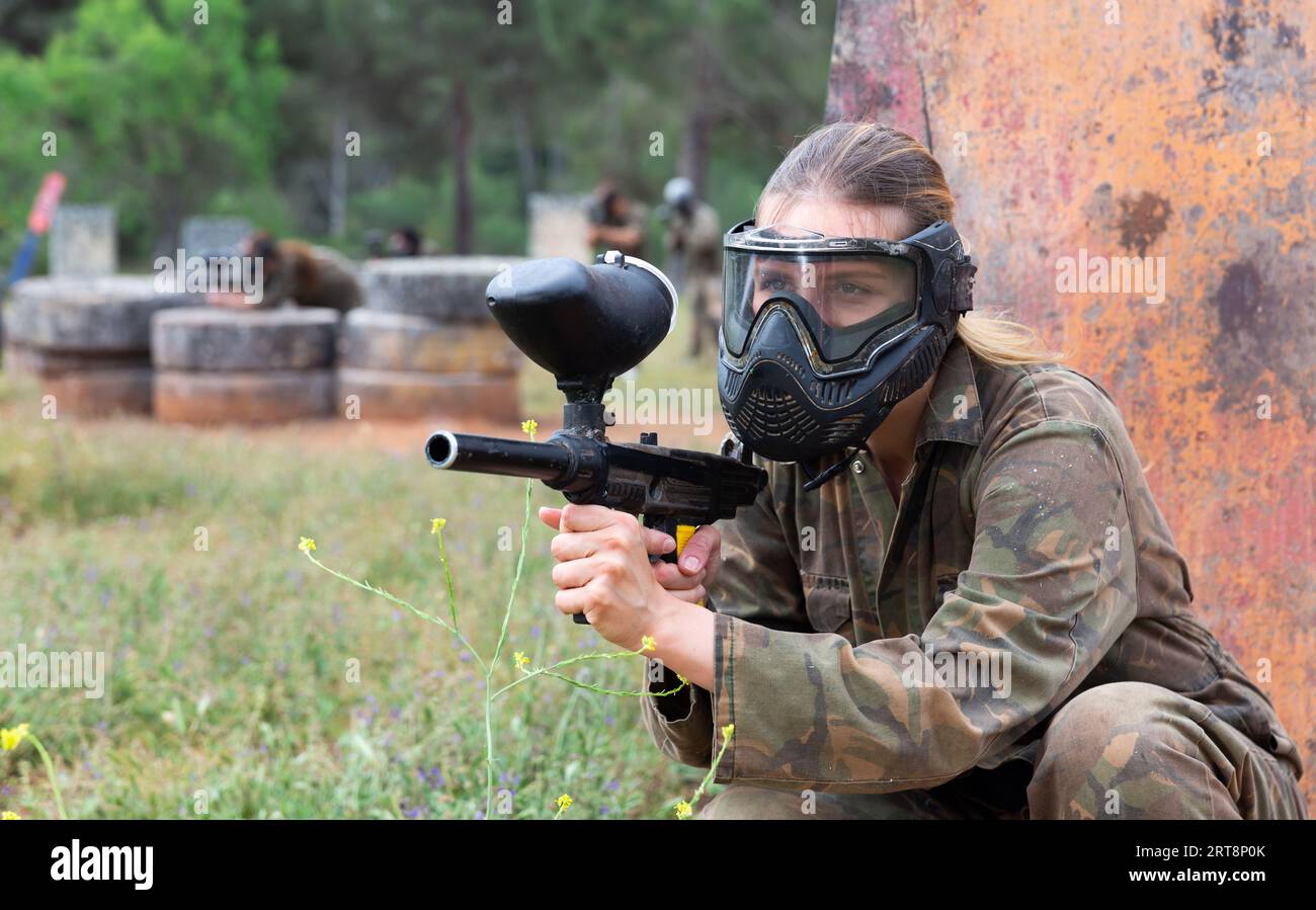Team of friends paintball players playing together in battle Stock ...
