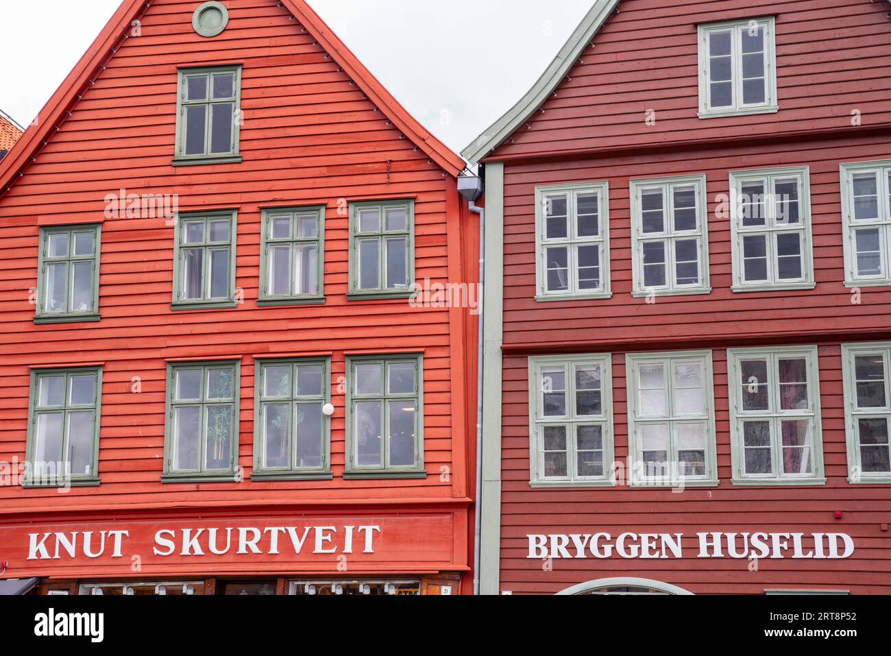 Tourists explore the UNESCO World Heritage site of Bryggen at the Bergen harbor; Bergen, Norway ...