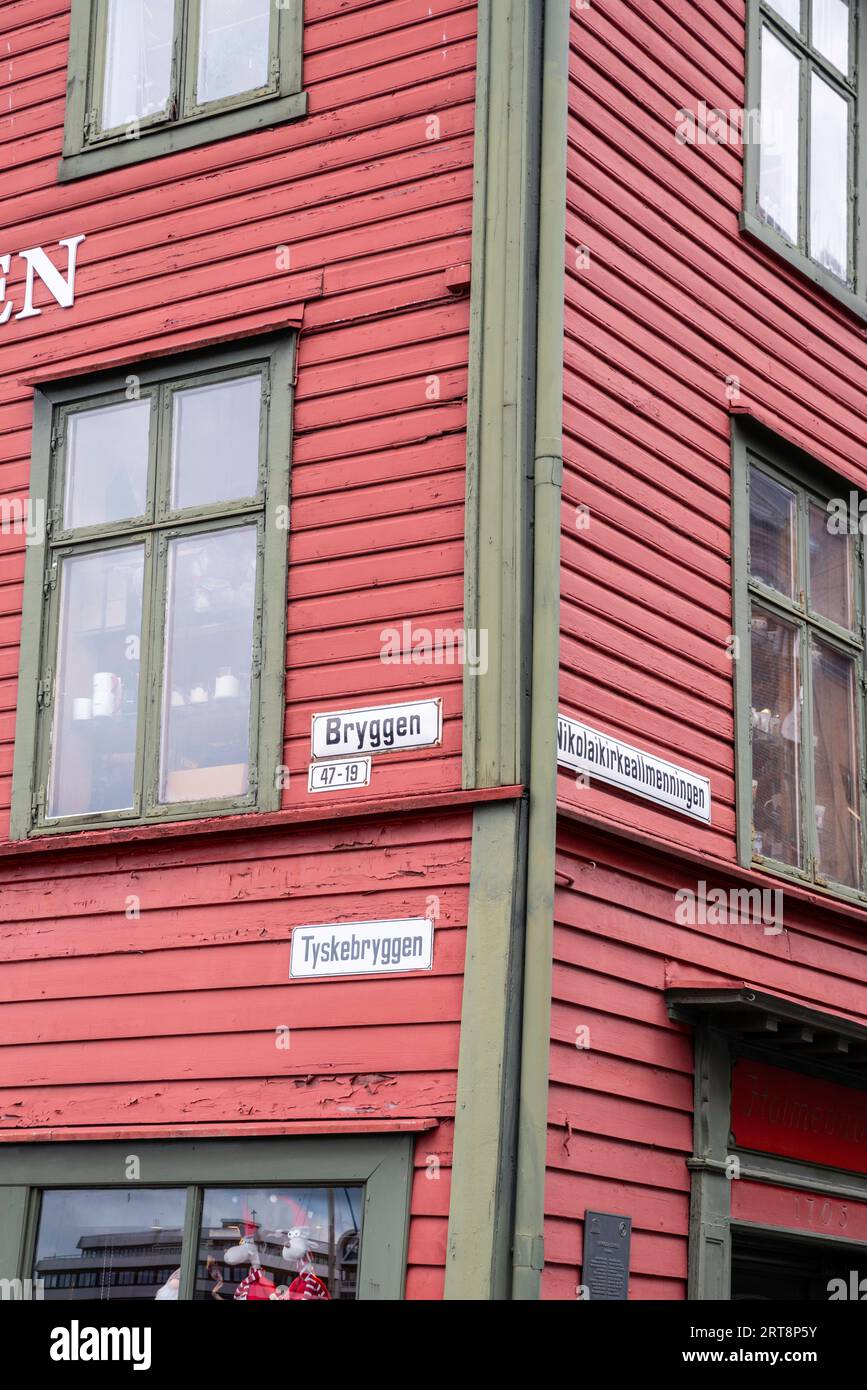 Tourists explore the UNESCO World Heritage site of Bryggen at the Bergen harbor; Bergen, Norway ...