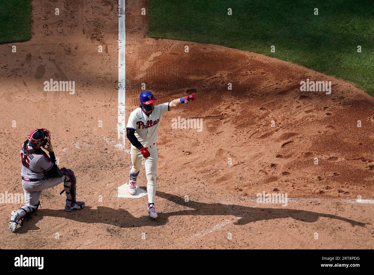 Philadelphia Phillies' Bryce Harper, right, reacts after hitting a two-run home run against ...