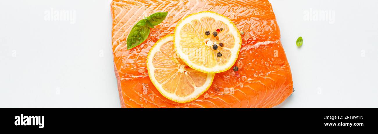 Fresh raw salmon marbled fillet isolated on white background with lemon ...