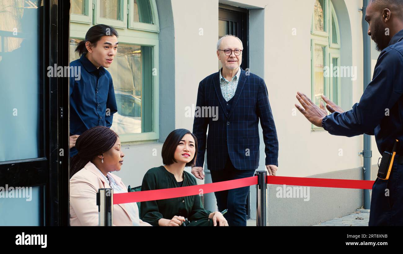 Crowd of people outdoors in line, gathering in the morning and wait to ...