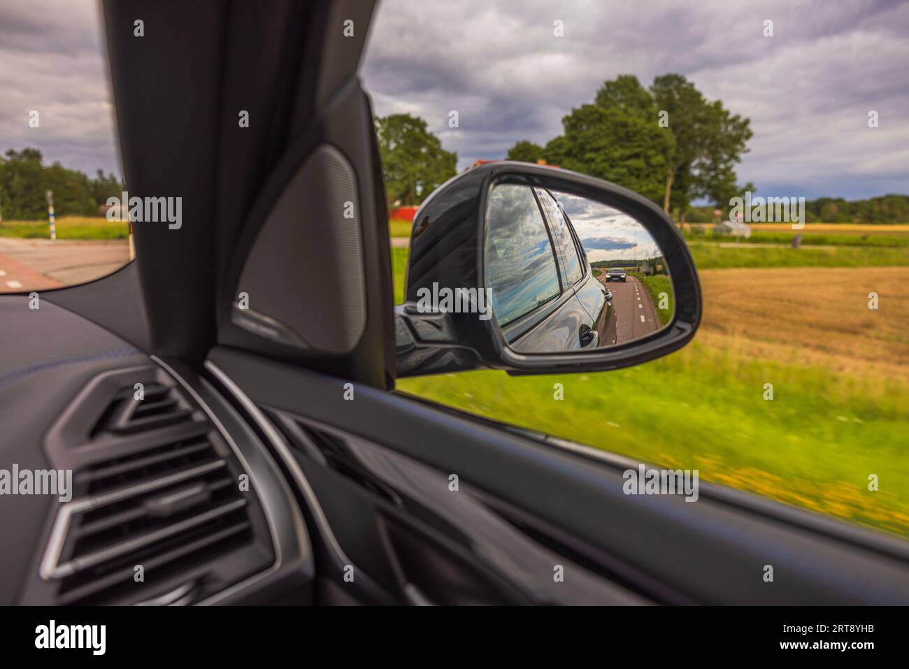 View of vehicle behind in side mirror of moving car. Sweden Stock Photo ...