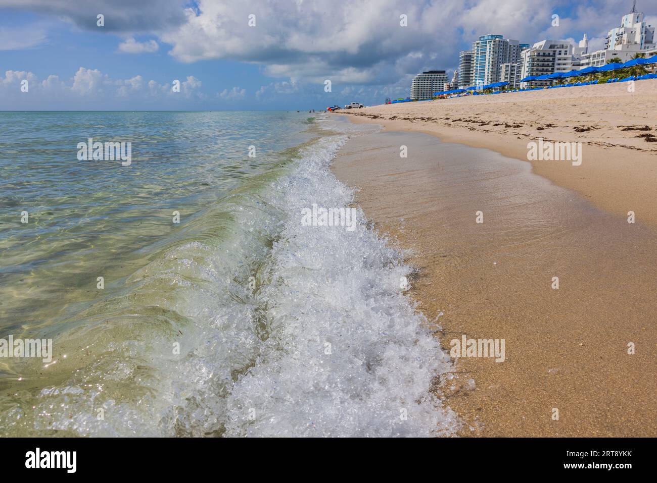 Beautiful view of wave rolling on to white sandy beach of Atlantic ...