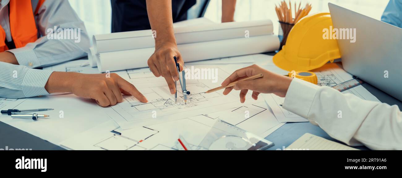 Architect or engineer working on building blueprint, contractor ...