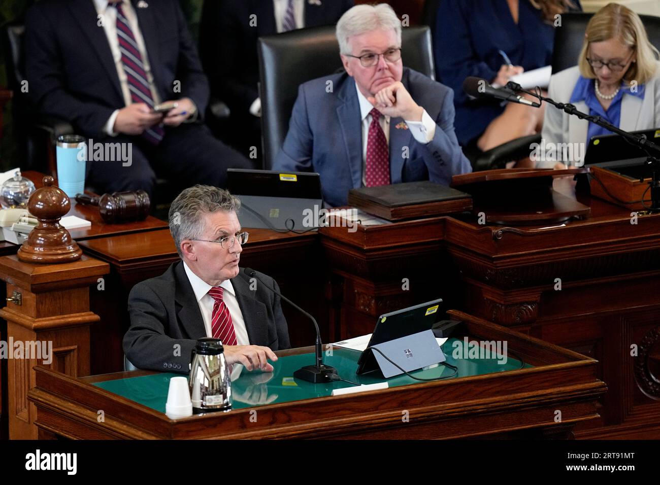 Texas Lt. Gov. Dan Patrick, top center, listens as witness Gregg Cox ...