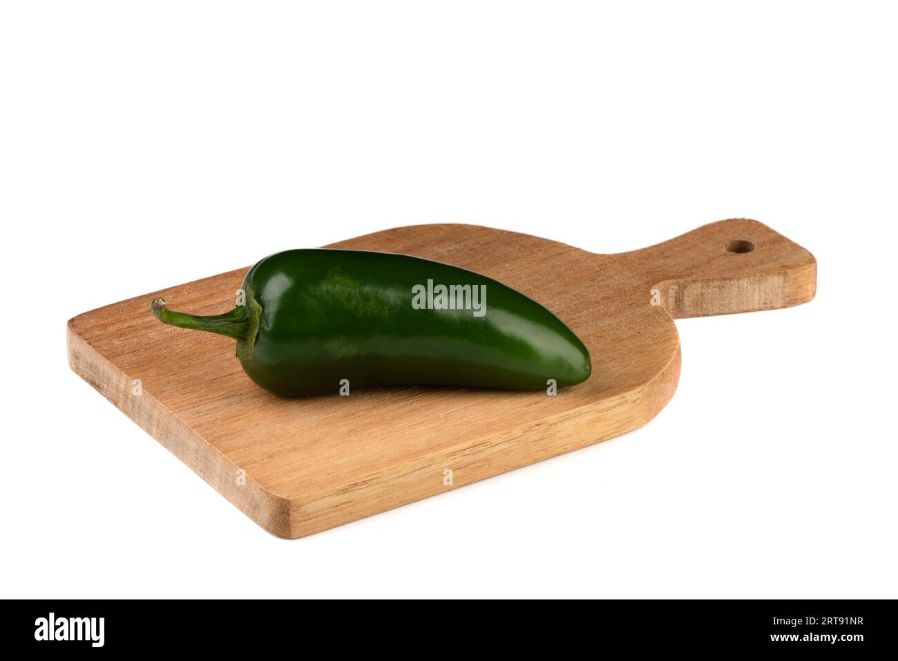 A pod of green hot pepper on a cutting board over a white background ...