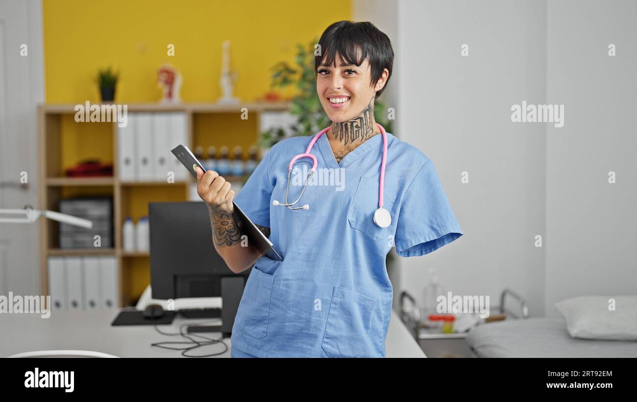 Hispanic woman with amputee arm doctor smiling confident holding ...