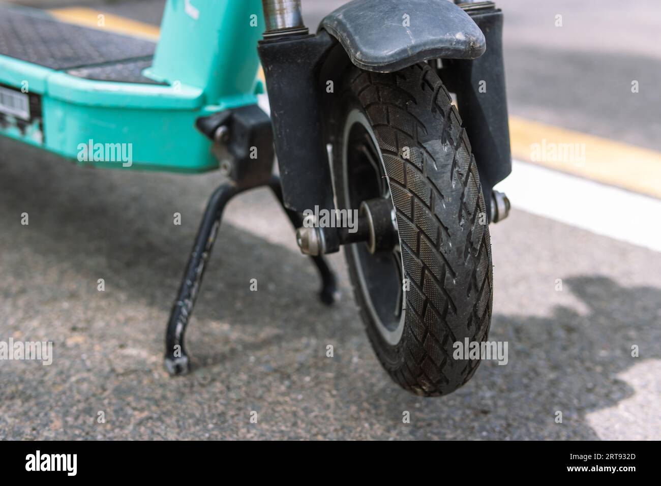 front wheel from an electric scooter close-up, the scooter stands on a ...